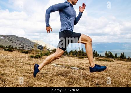 Male legs. Side view of the muscular legs of an athletic, physically ...