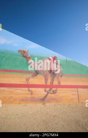 Painted overpass on roadway. It depicts camel racing with robot jockey ...