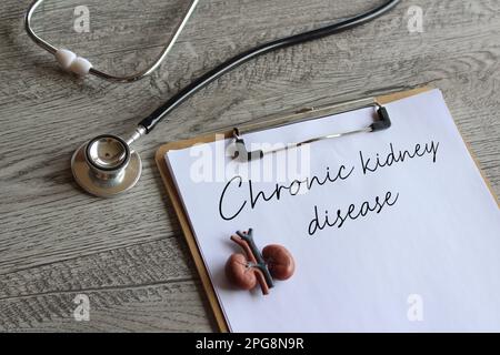 Stethoscope, kidney model and paper clipboard with text Chronic Kidney ...