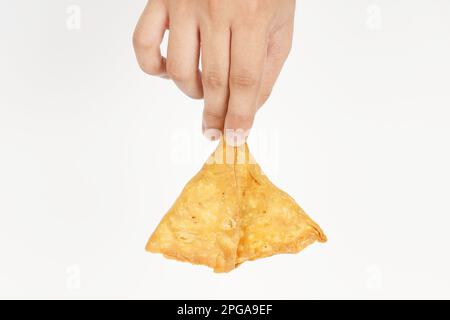 Samosa in hand on white background Stock Photo - Alamy