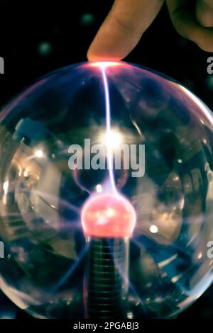 Electricity lighting ray going to a finger hand on a powerful spark ...
