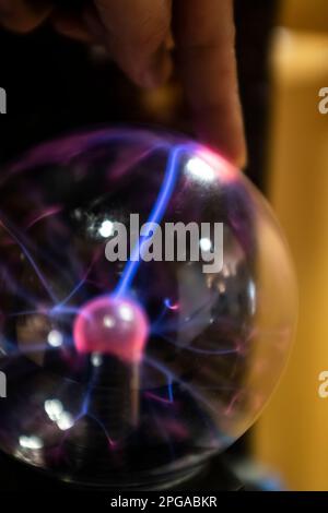 Electricity lighting ray going to a finger hand on a powerful spark ...