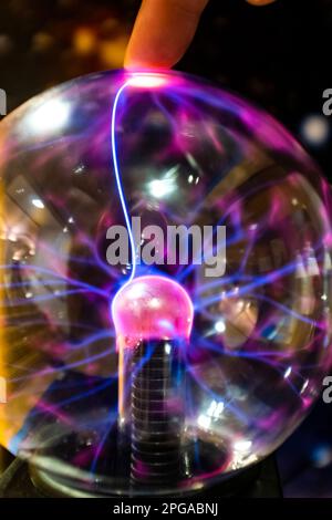 Electricity lighting ray going to a finger hand on a powerful spark ...