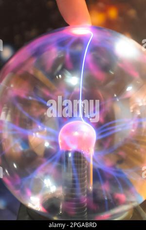 Electricity lighting ray going to a finger hand on a powerful spark ...