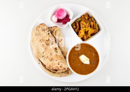 Dal makhani mix veg with tandoori roti in white plate isolated on white ...