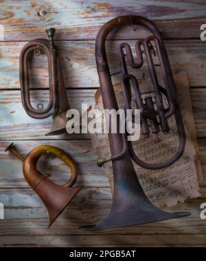 Rusty trumpet on musical notes, top view. Music notes book and trumpet ...
