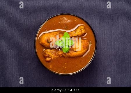 Tari wala murga spicy chicken leg piece curry Stock Photo - Alamy