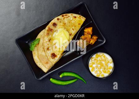 Top view of butter paratha with raita and pickle, healthy indian food ...