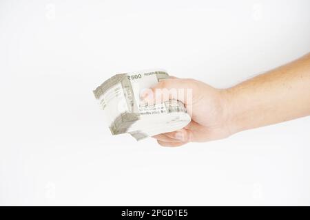 Bundle of indian rupees in hand on white background Stock Photo - Alamy