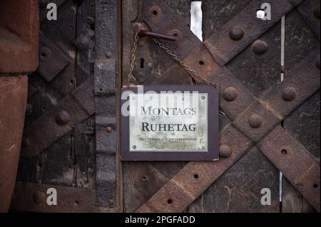 German Montags Ruhetag, Monday rest day sign at the metal wooden castle ...