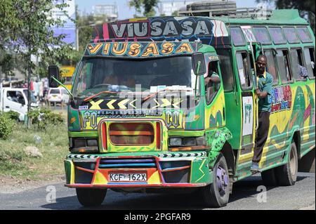 KENYA, Nairobi, Graffiti street art and traffic, colorful painted SACCO ...