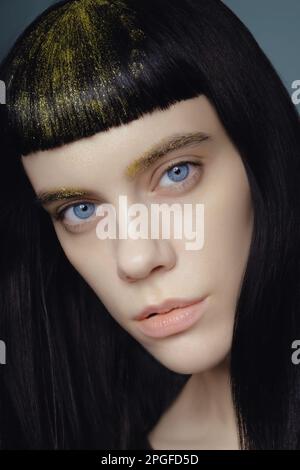 Model with gold glitter at brows and hair Stock Photo - Alamy