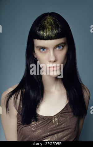 Model with gold glitter at brows and hair Stock Photo - Alamy