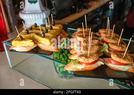 Tapas (pintxos, sandwich) with a small chicken cutlet and a slice of ...