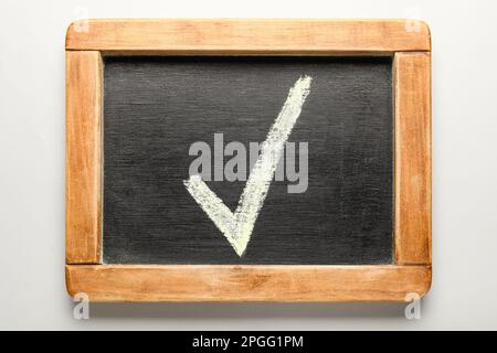 Check mark on blackboard, top view Stock Photo - Alamy