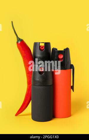 Sprays with chili pepper on yellow background Stock Photo - Alamy