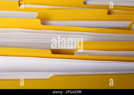 Many yellow files with documents as background, closeup Stock Photo - Alamy