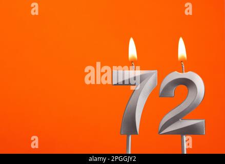 Candle number 72 - Birthday in blues foamy background Stock Photo - Alamy