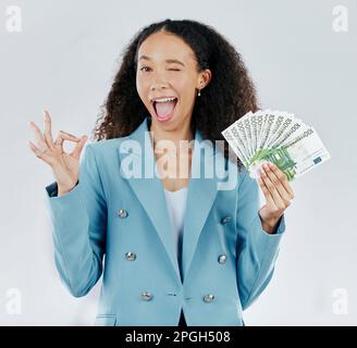 Happy girl smiling making winning gesture in casual pink hoodie and ...
