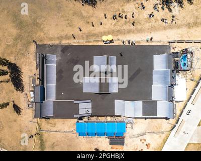 Aerial view of a skate park featuring ramps, rails, and half-pipes for ...