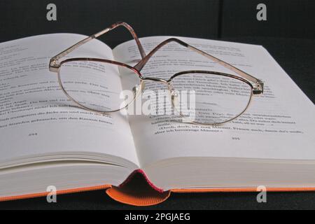 reading specs on an open book Stock Photo - Alamy
