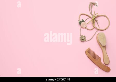 Wooden hair comb for baby on pink background Stock Photo - Alamy