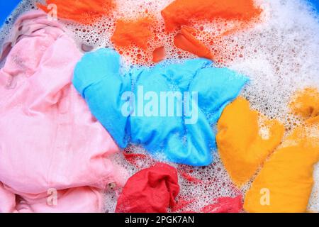 Colorful clothes in suds, top view. Hand washing laundry Stock Photo ...