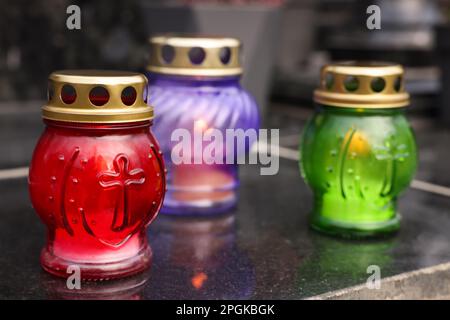 Different grave lanterns on granite surface at cemetery Stock Photo - Alamy