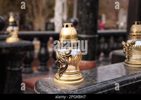 Grave lanterns on granite surface at cemetery Stock Photo - Alamy