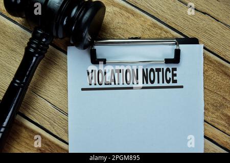 Violation Notice write on a paperwork isolated on Wooden Table Stock ...