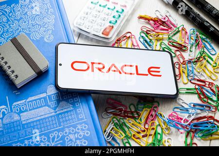 In this photo illustration ,a Oracle logo is seen displayed on a ...