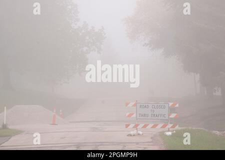 Road Construction Barricade in Fog with Closed to Thru Traffic Sign ...