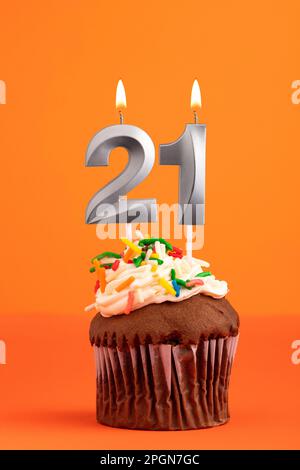 Birthday cake with candle number 21 - Blue background Stock Photo - Alamy