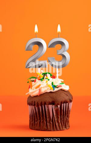 Candle number 23 - Cake birthday in orange background Stock Photo - Alamy