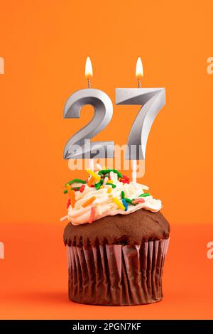 Birthday cake with candle number 27 - Rhodamine Red foamy background ...