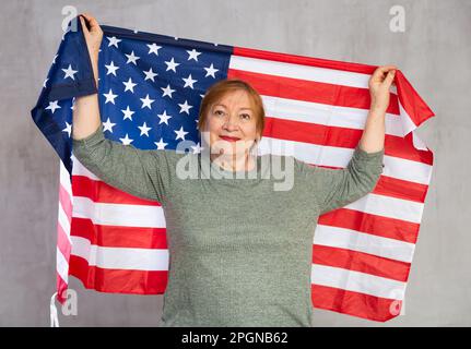 Smiling elderly woman waving flag of Austria in studio Stock Photo - Alamy
