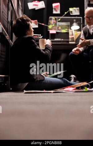 Overworked woman private detective analyzing investigation report and ...