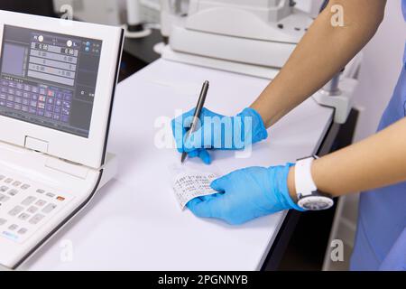 midsection of doctor writing on paper at clinic Stock Photo - Alamy