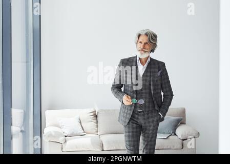 Conception of beautiful style. Senior stylish modern man with grey hair ...
