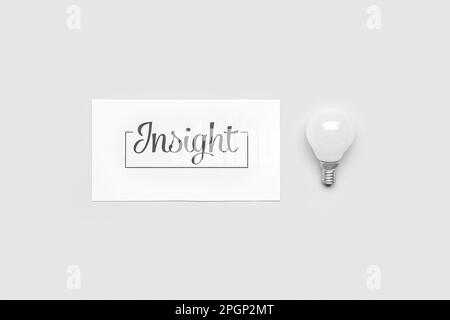 Paper with word INSIGHT and light bulb on light background with space ...