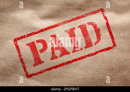 Kraft paper with stamp PAID, top view Stock Photo - Alamy