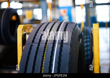 Finished tire with yellow and white color lines on rod at factory Stock ...