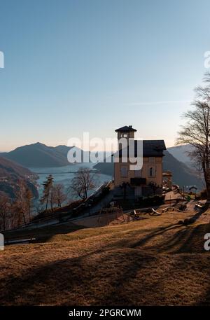 Amazing sunny winter view of Lugano with snow-capped foresty mountains ...
