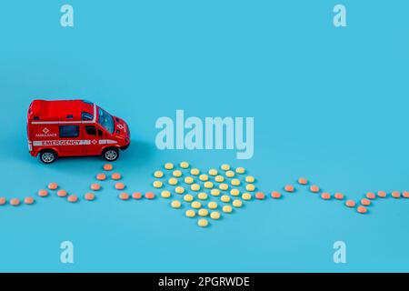 Drawing of a cardiogram from pills on a blue background and ambulance ...