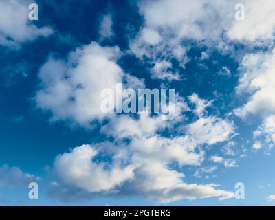 White summer clouds drifting across a vivid blue sky background Stock ...