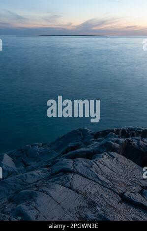 Dusk over the granite rocks of the Canadian Shield rocks and the waters ...