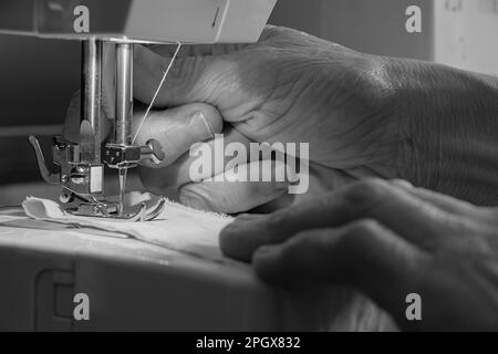 sewing machine and old grandmother's hand Stock Photo - Alamy
