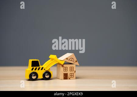 The bulldozer demolishes the house. Encroachment on private property ...