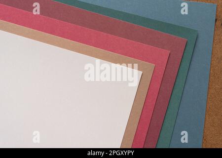 scrapbook paper background featuring layered sheets in various colours ...