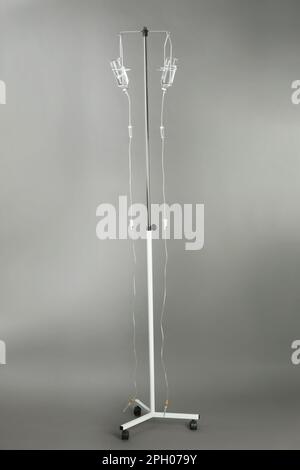 Drop counter with bottles of medicine on grey background Stock Photo ...
